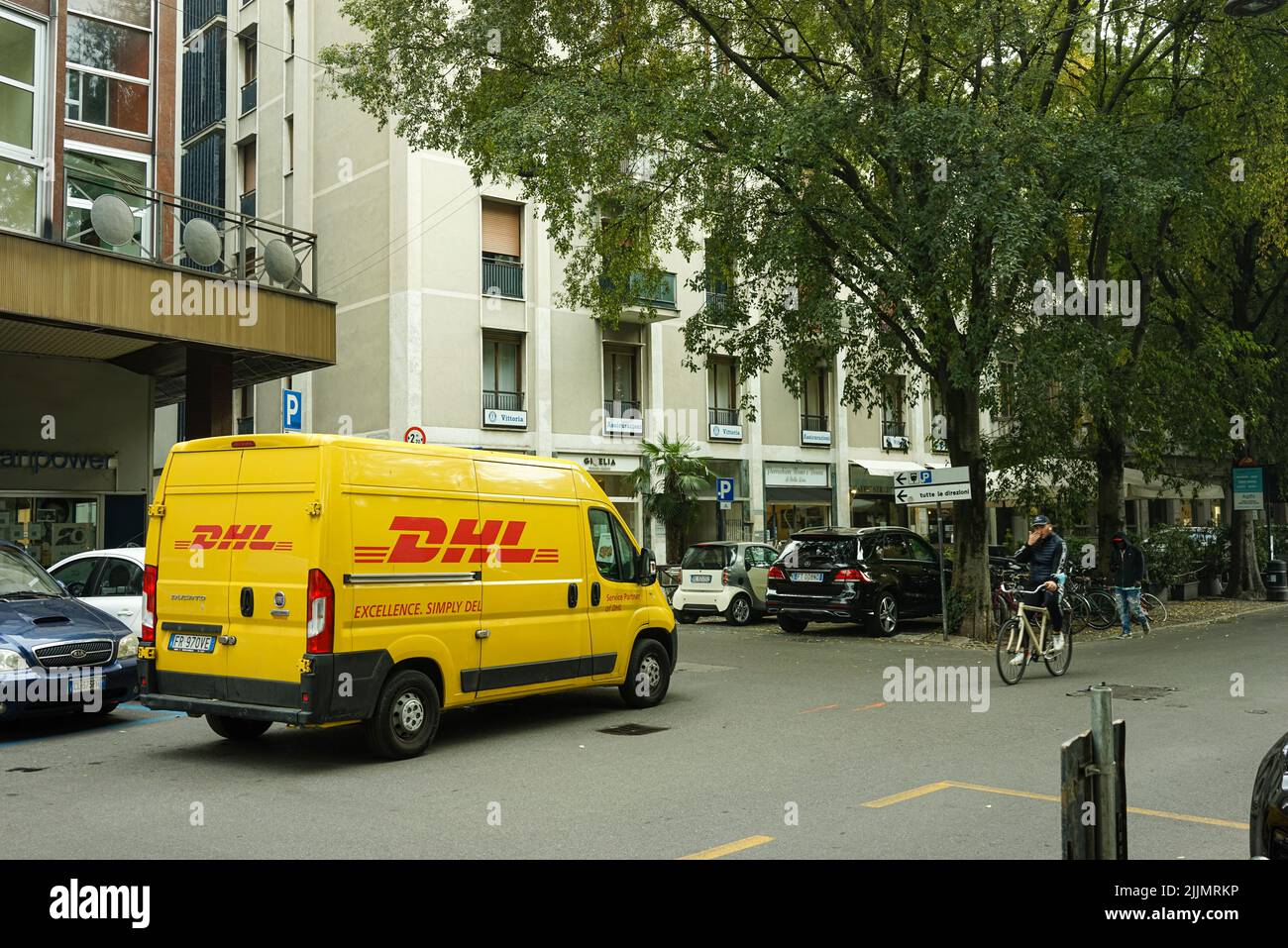 A DHL cargo courier van delivering shipping packs Stock Photo - Alamy