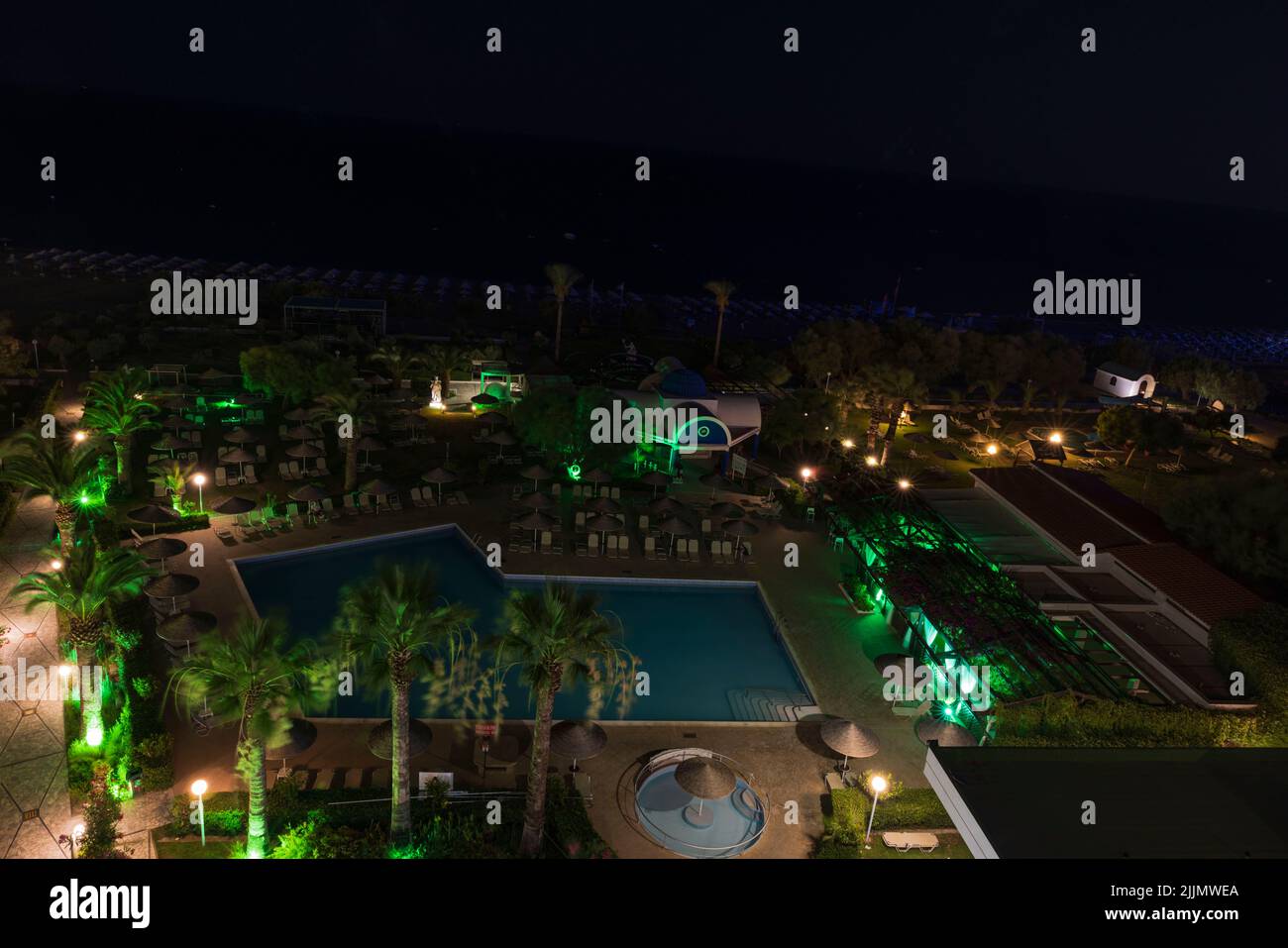 Beautiful night view of hotel with outdoor pool and beach in ...