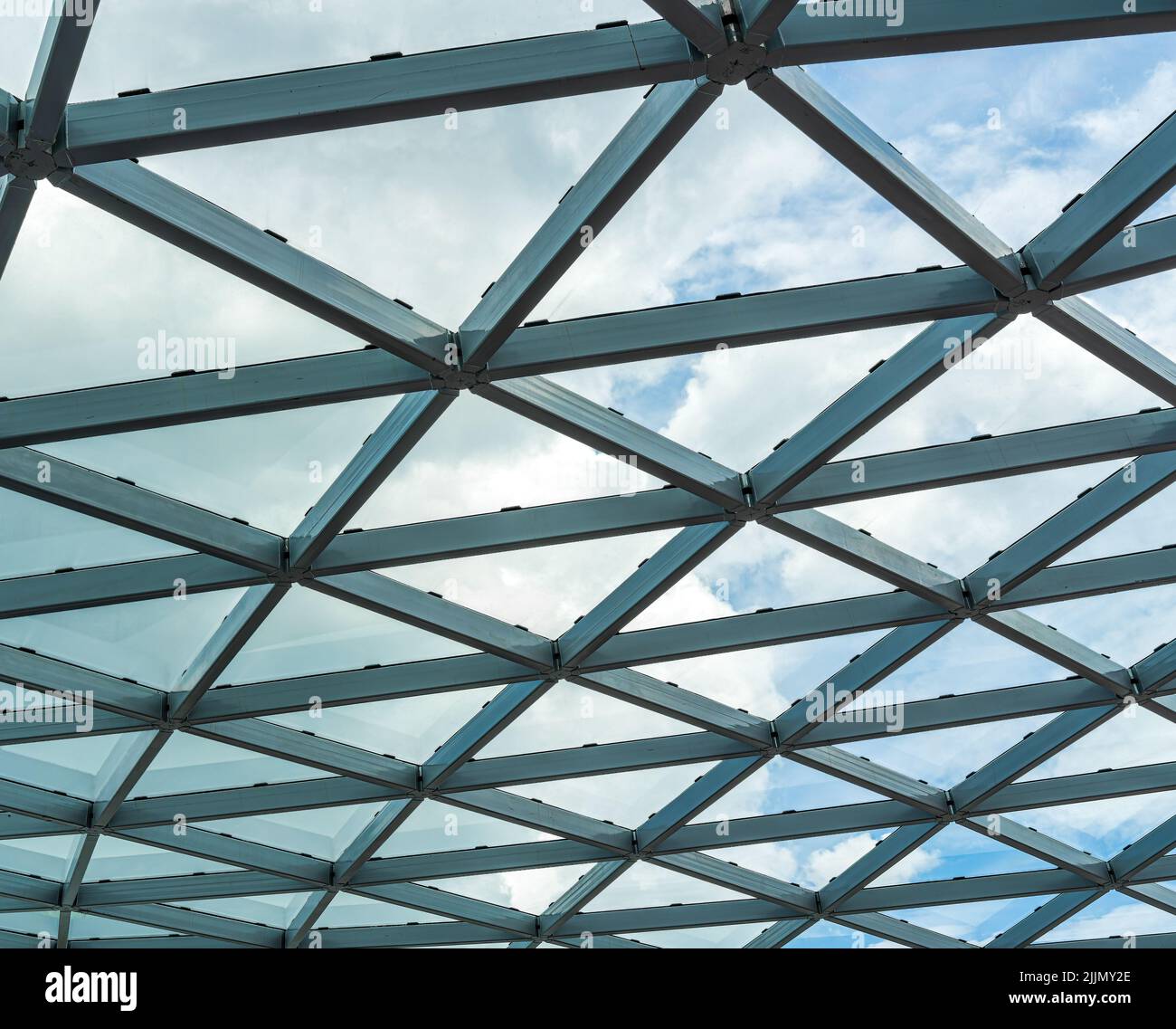 Glass metal framed roof of a modern building. Abstract architectural ...