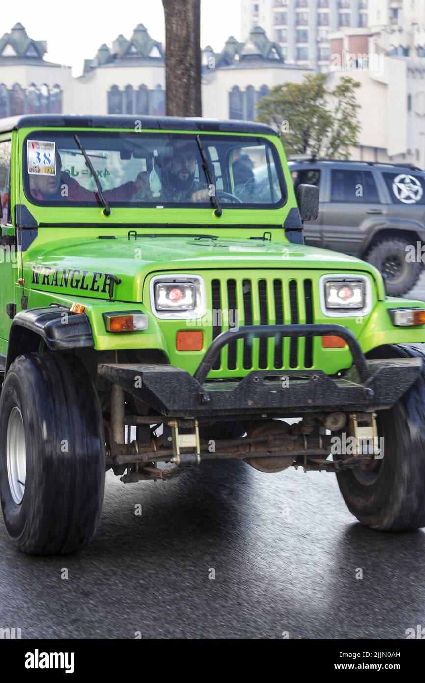 A vertical shot of a gorgeous green Jeep Wrangler modified for dirt ...