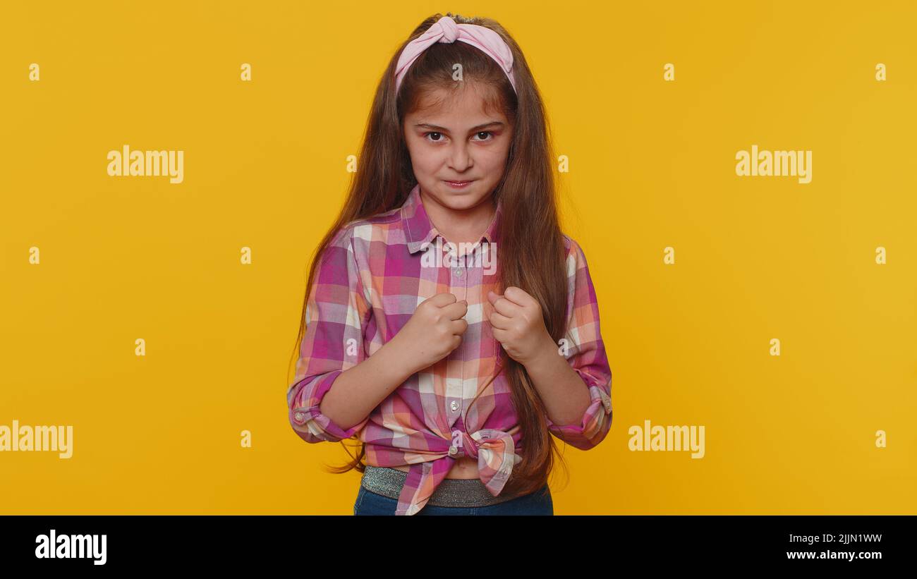 Aggressive preteen child girl kid making fight threat at camera ...