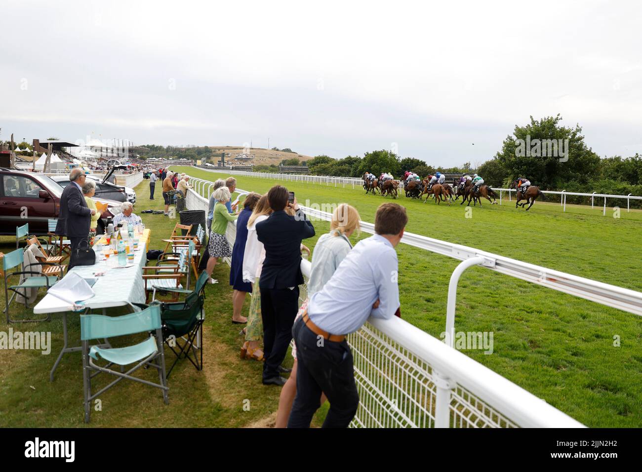 Racegoers watch by their cars and picnic tables during the World Pool ...