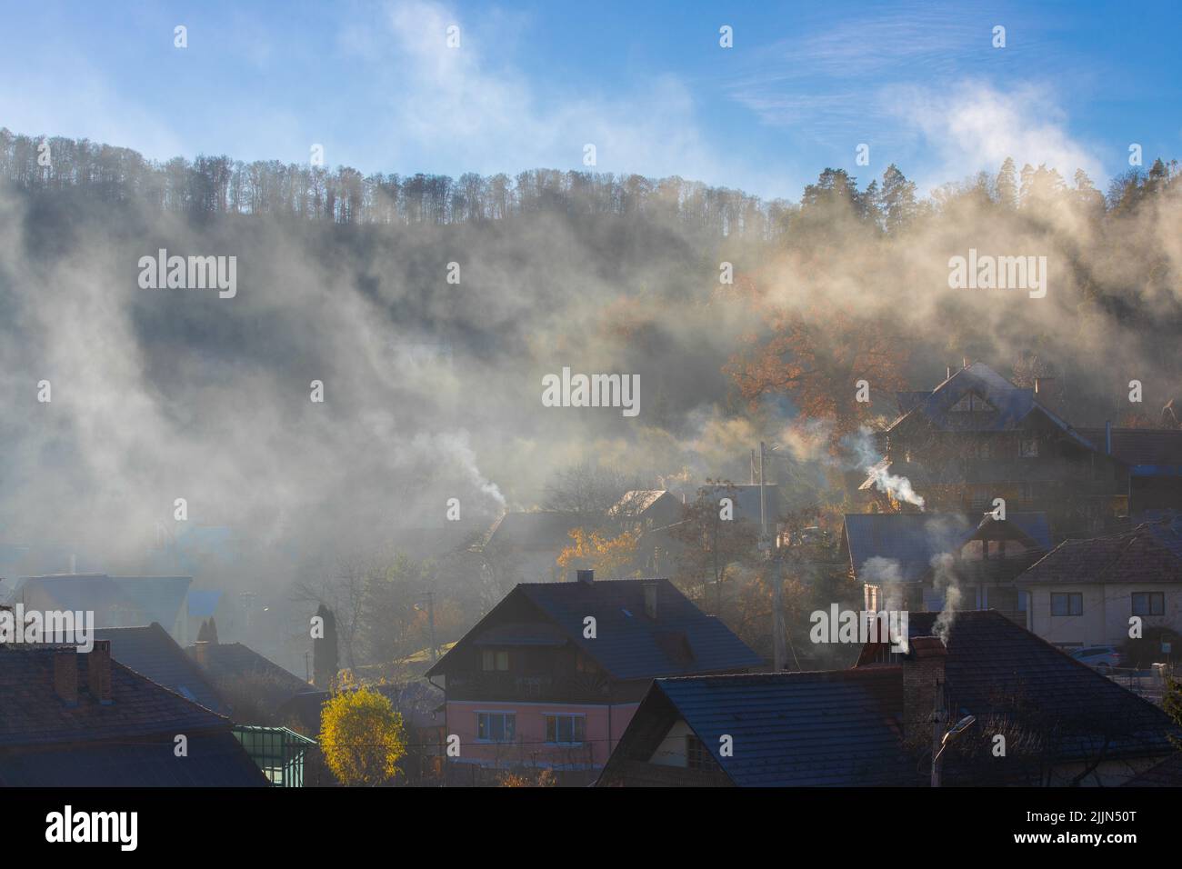The smoke and fog over the houses in the village Stock Photo - Alamy