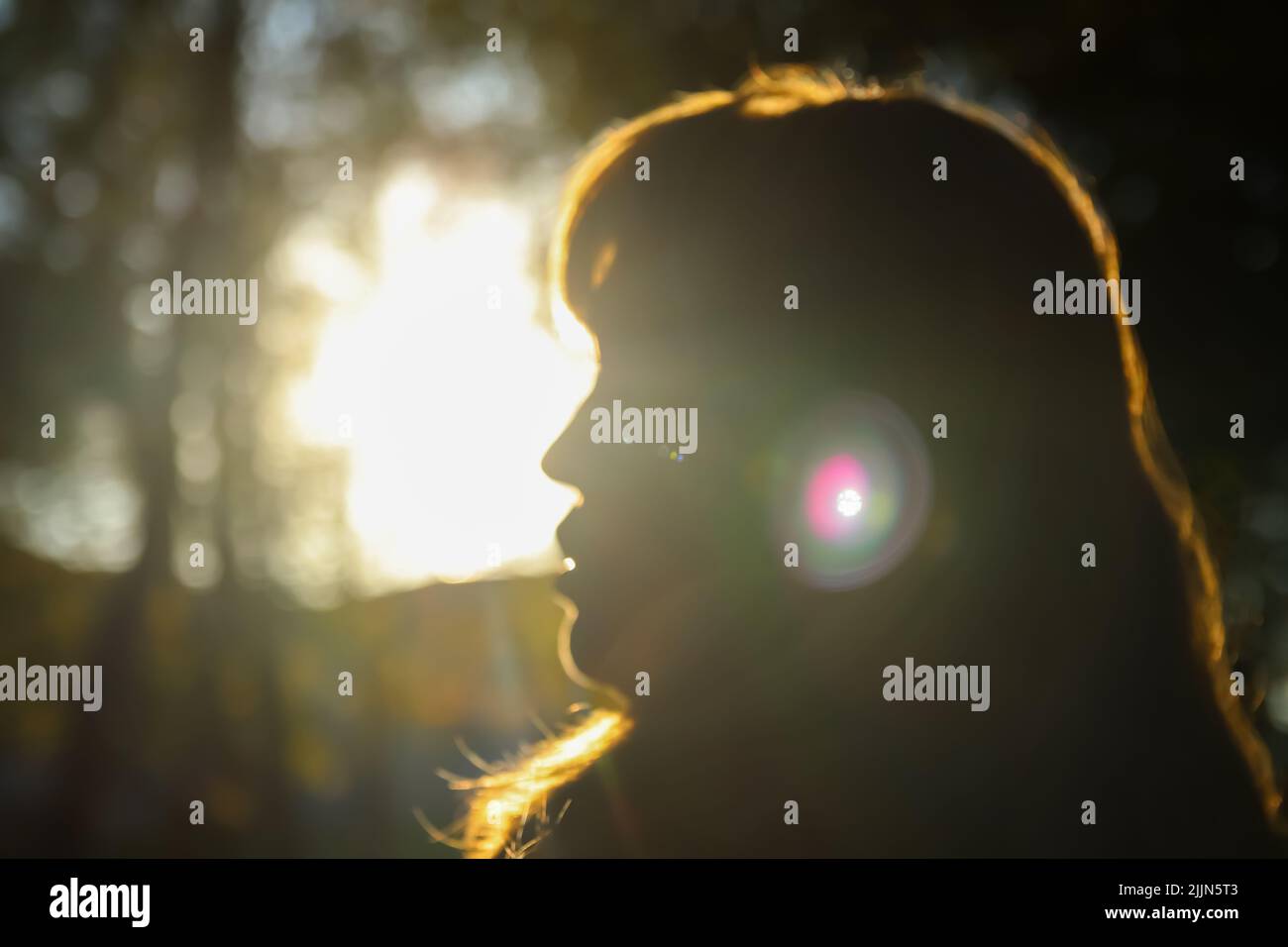 Defocus close-up silhouette of woman looking at sunrise. Mental health ...