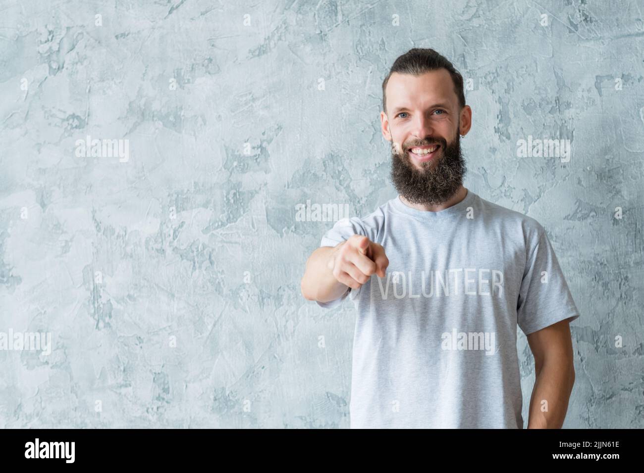 man volunteer pointing index finger call to action Stock Photo - Alamy