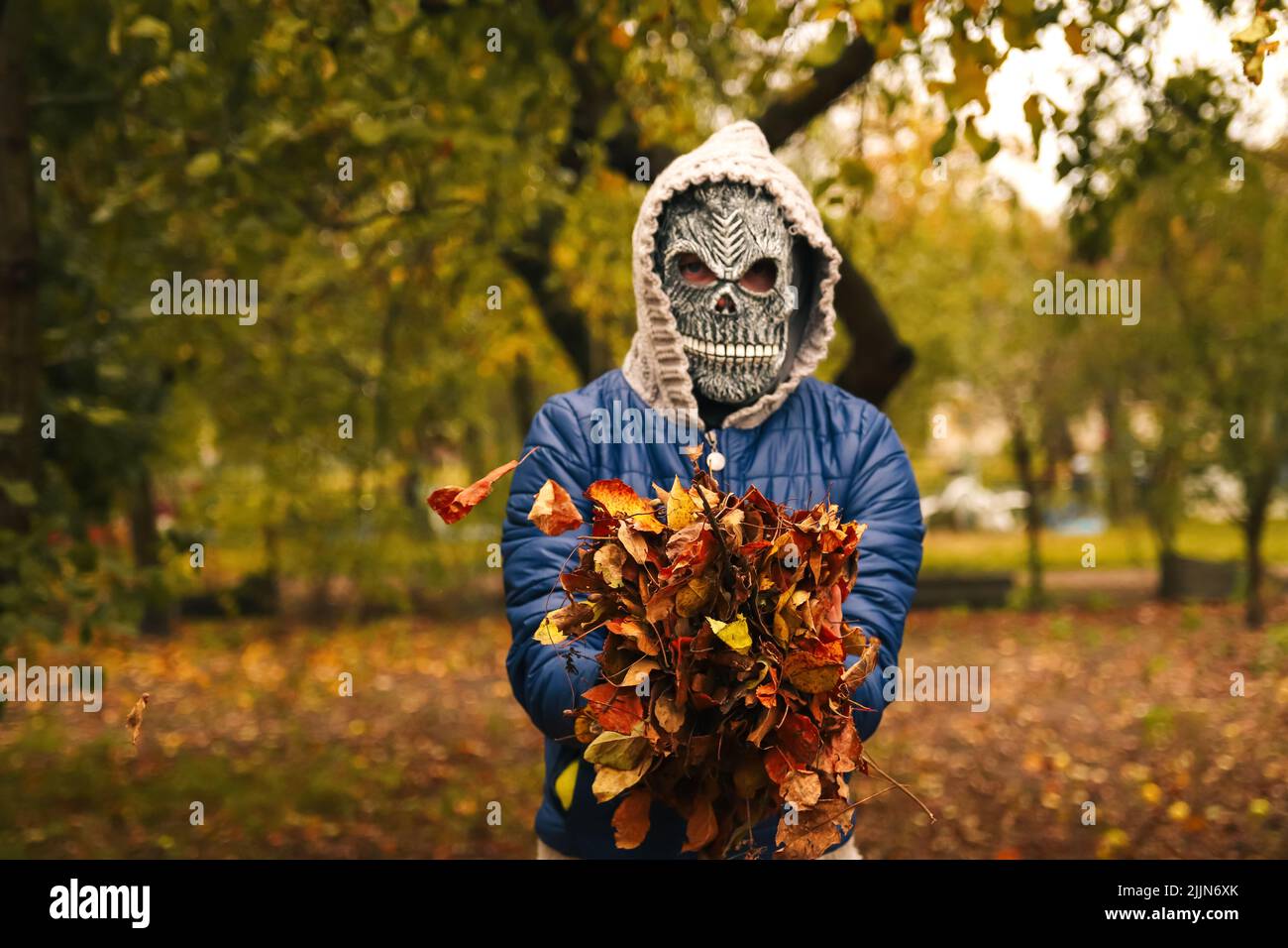 Defocus Halloween people portrait. Person in grim reaper mask standing ...