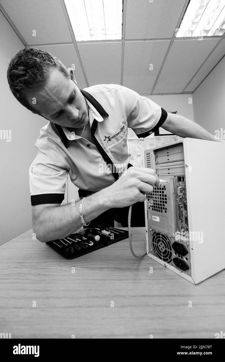 A closeup of an IT service and maintenance professional working on a ...