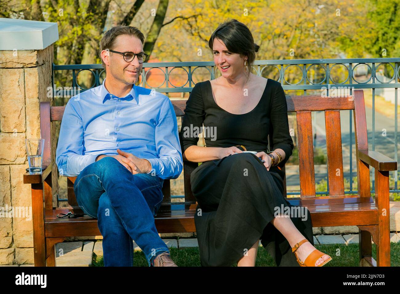 The male and female VIP guests communicating at an outdoor social event ...