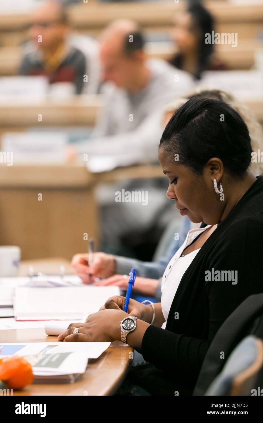 A vertical shot of delegates attending a business lecture in a ...