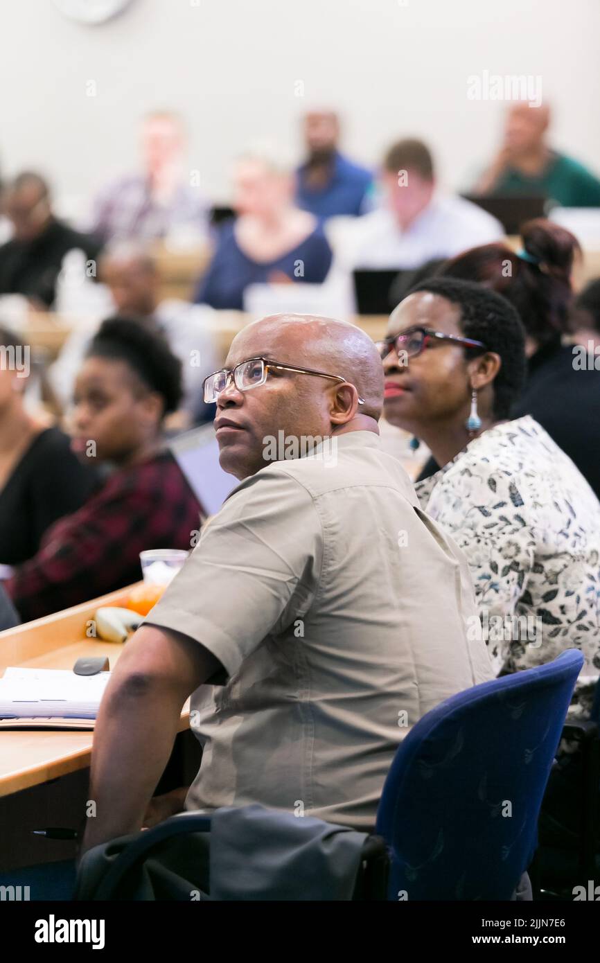 A vertical shot of delegates attending a business lecture in a ...