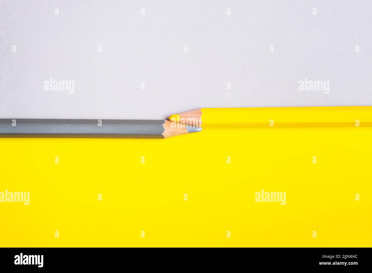yellow and gray pencil on a background of the same inverted color ...