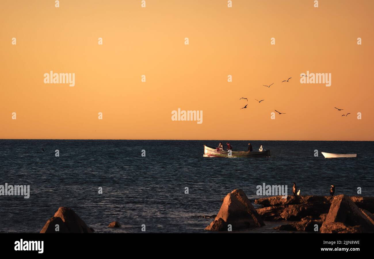 Calm ocean with a fishing boat hi-res stock photography and images - Alamy