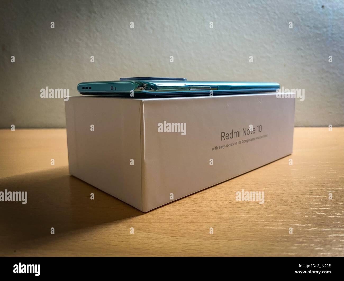 A Closeup of a Xiaomi - Redmi Note 10 - Lake green color on a box Stock ...