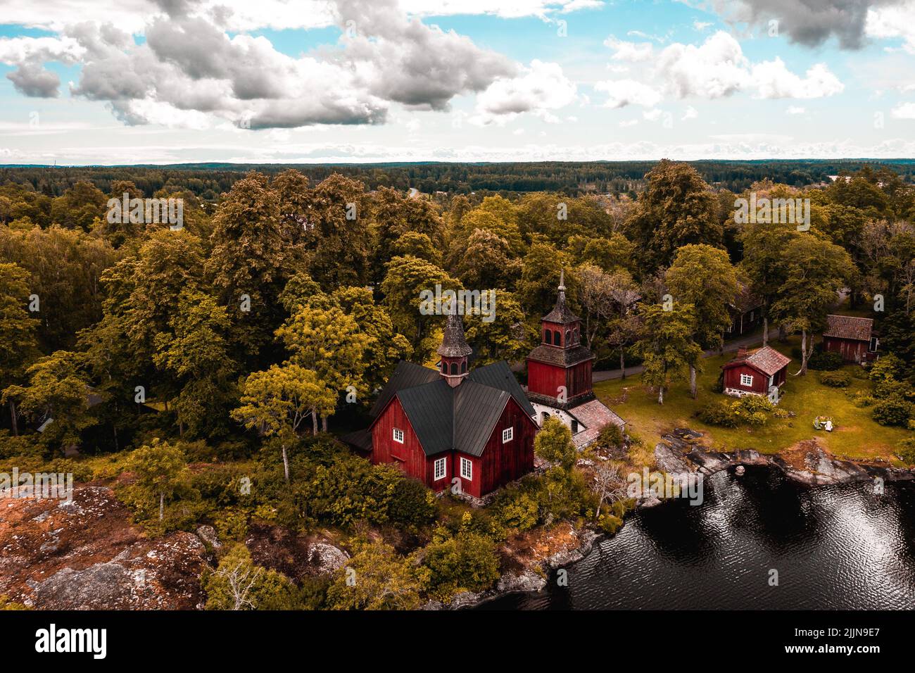 An aerial view of land with buildings surrounded by trees in the old ...