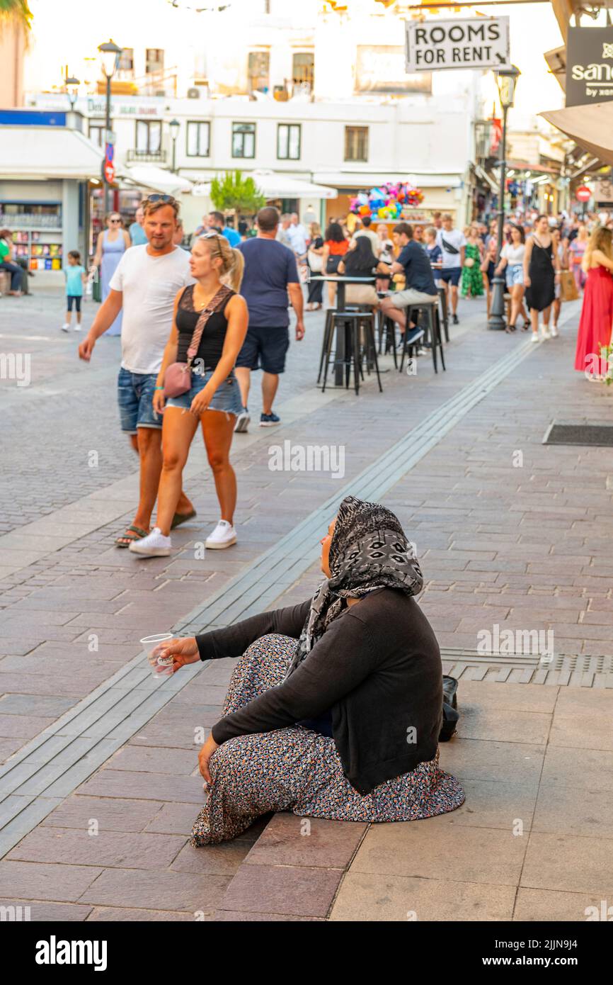 lady begging on a street in chania on the greek islands of crete ...