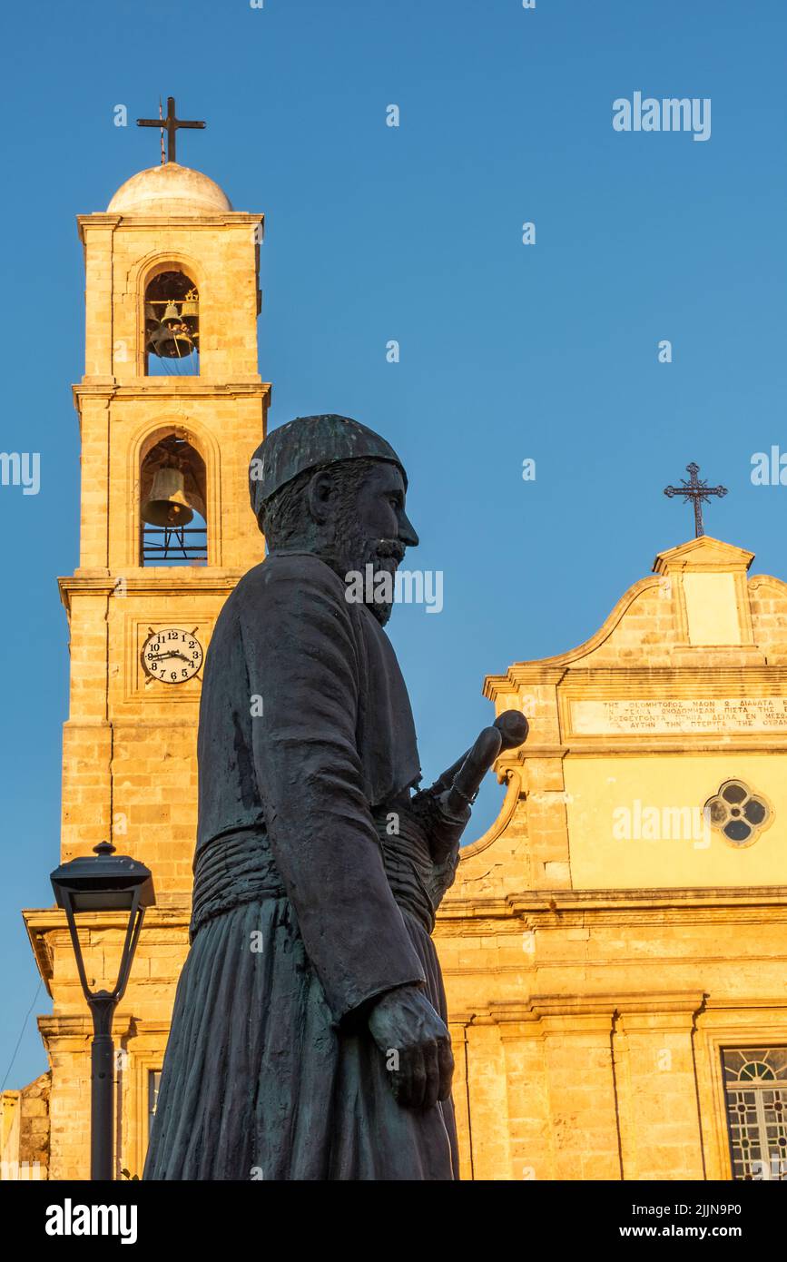 greek orthodox church and statue of saint in the square in the town of ...