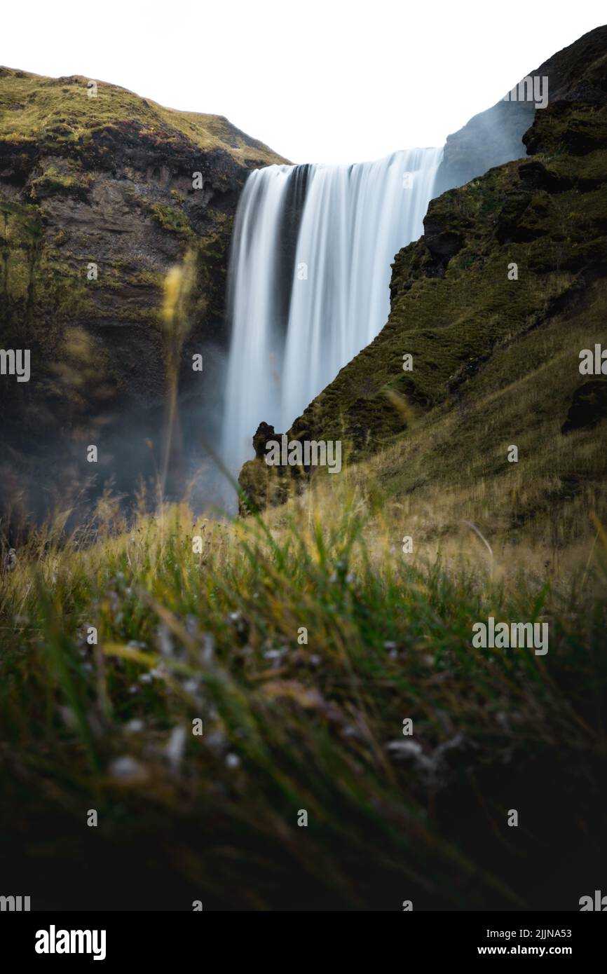 A vertical shot of Skogafoss waterfall in Iceland with long exposure ...