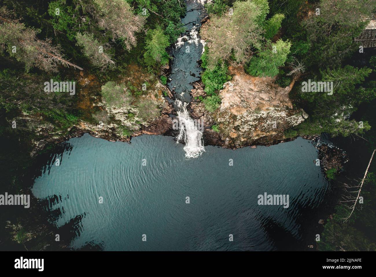 A breathtaking scenic top view of a waterfall in a dark forest Stock ...