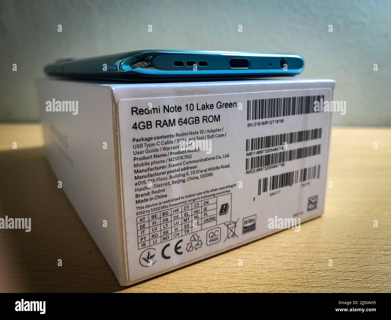 A closeup of a Xiaomi - Redmi Note 10 - Lake green color on a box Stock ...