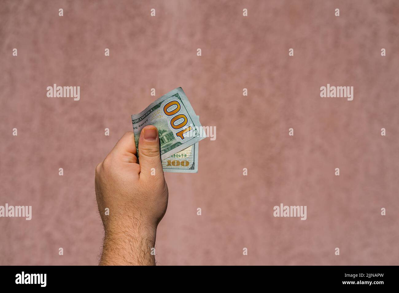 A man hand giving money - holding 100 dollars Stock Photo - Alamy