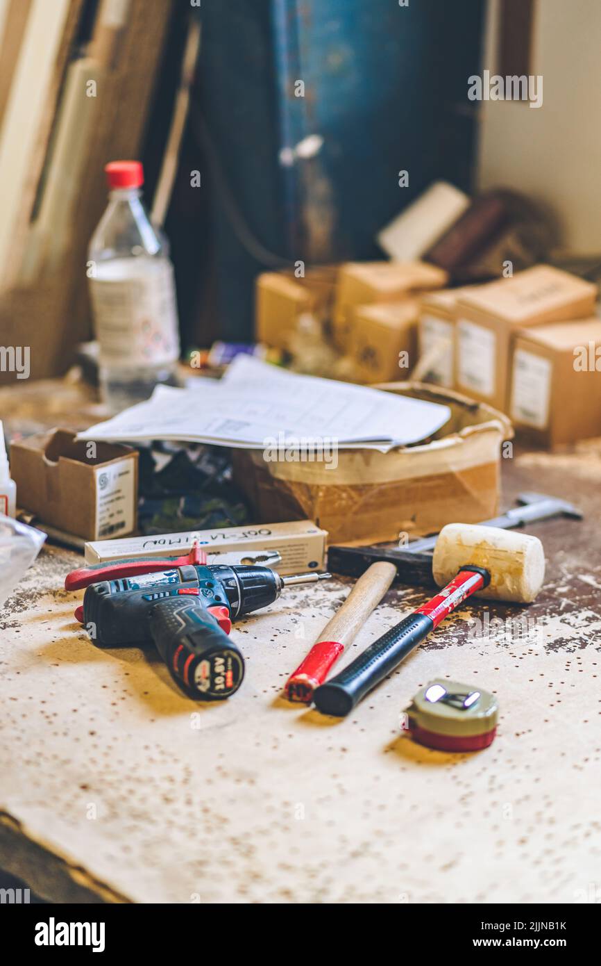 A table full of working tools in the warehouse Stock Photo - Alamy