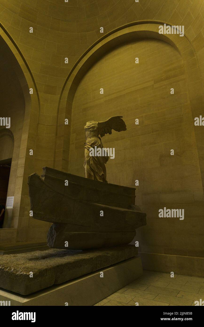 A vertical shot of the statue of Nike in the Louvre museum in Paris ...
