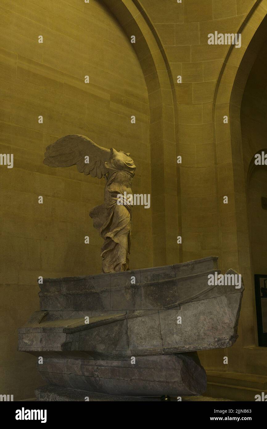 A vertical shot of the statue of Nike in the Louvre museum in Paris ...