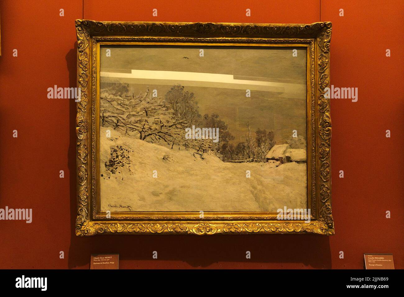 A painting hanging on the red wall of the Louvre museum, Paris, France ...