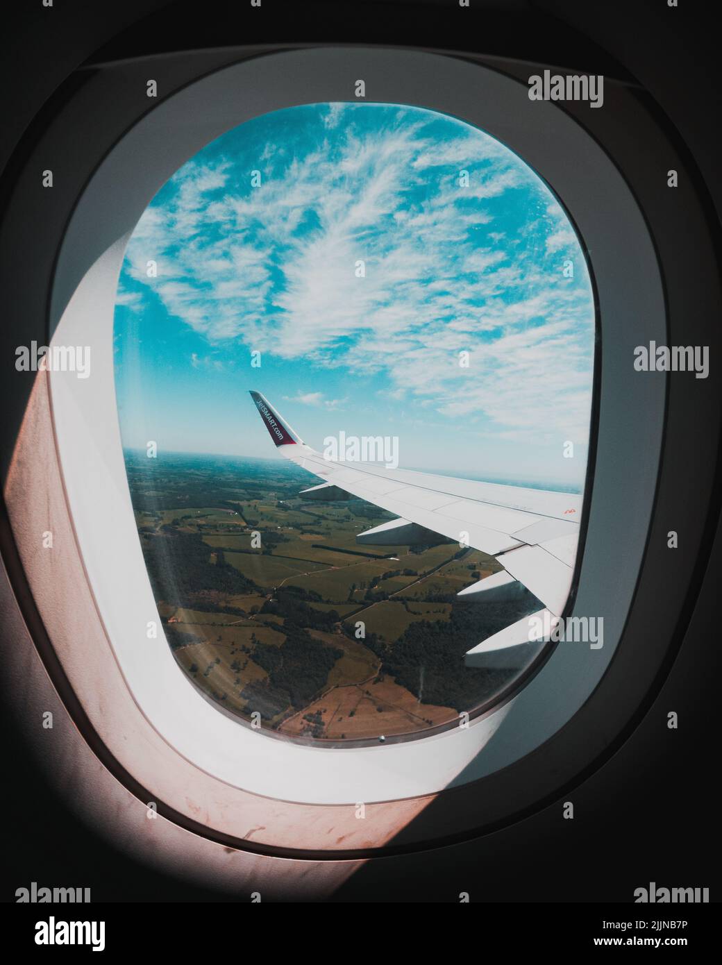 A wing of an airplane from its window Stock Photo - Alamy