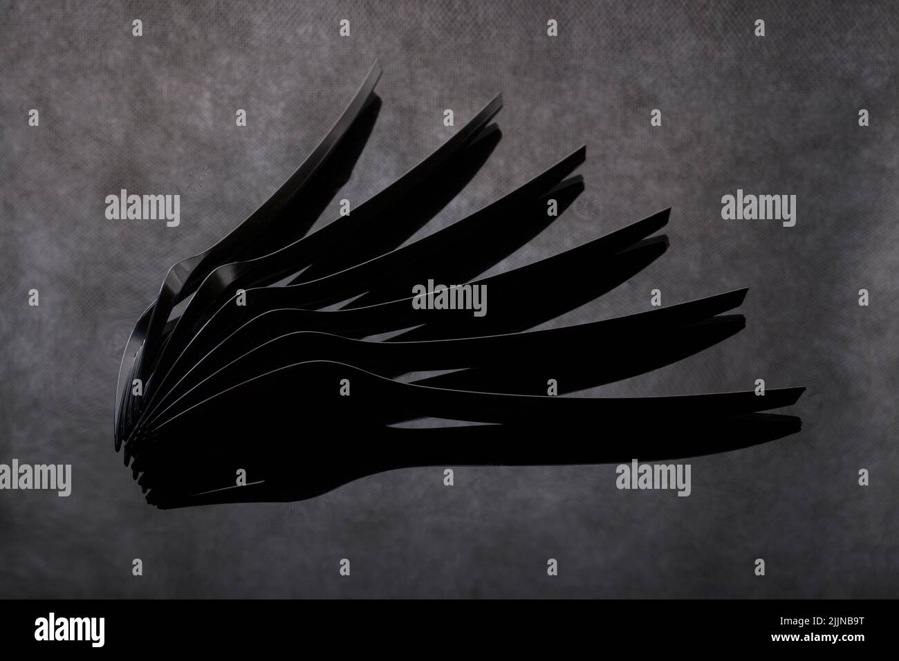 Abstract figure of black forks on a gray surface Stock Photo - Alamy