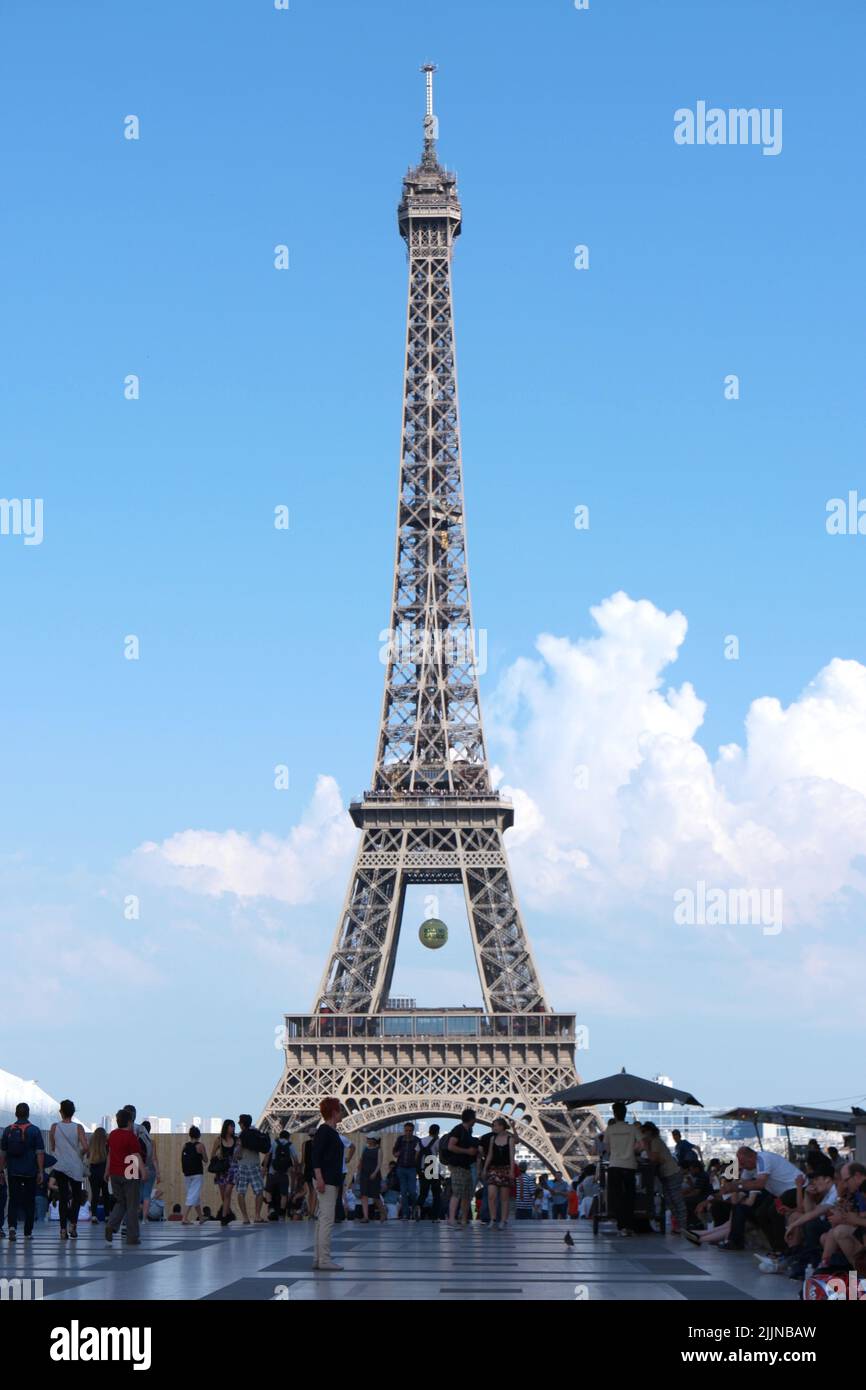 A vertical shot of the Eiffel Tower in Paris, France on blue sky ...