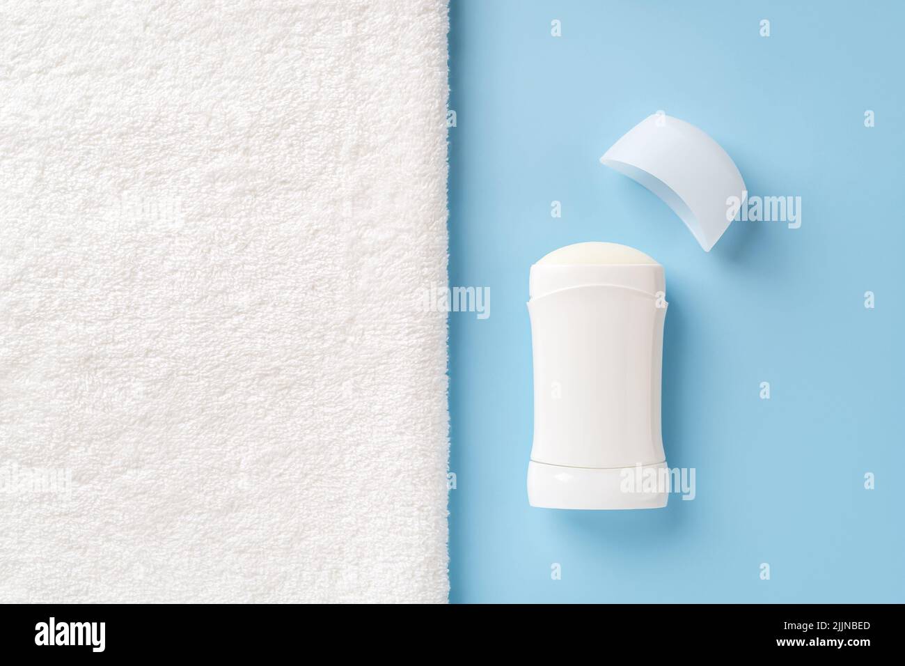 Solid antiperspirant deodorant on a blue background and white bath ...