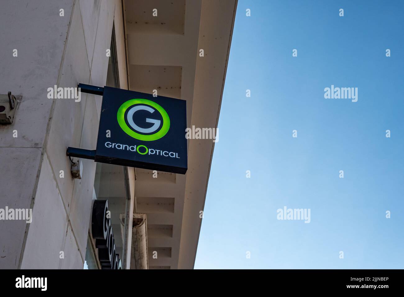 A closeup shot of the Grand Optical optician store logo Stock Photo - Alamy