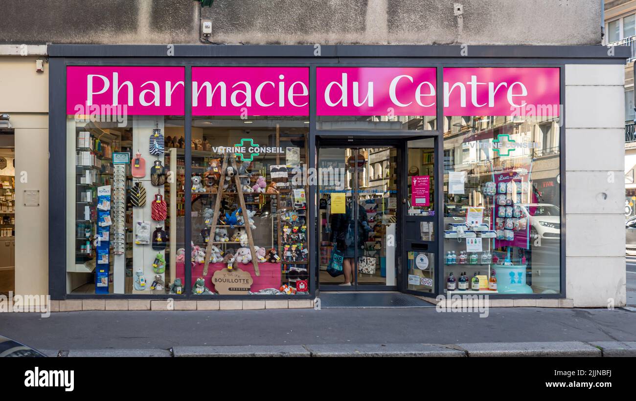 A French pharmacy (Pharmacie du centre) front store facade view with ...