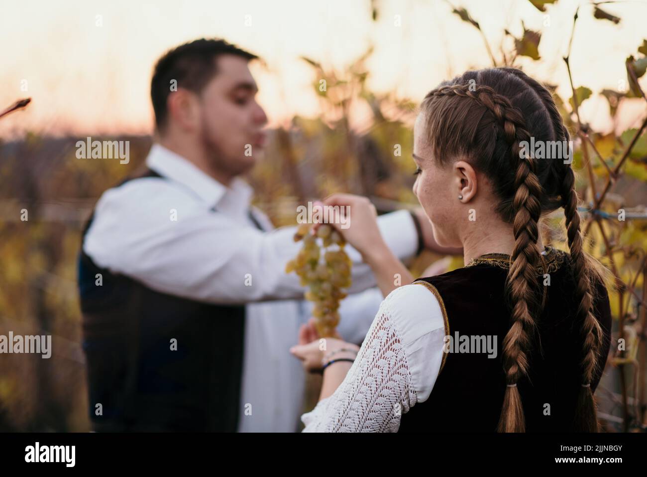 A beautiful shot of a Serbian couple in traditional costumes posing for ...