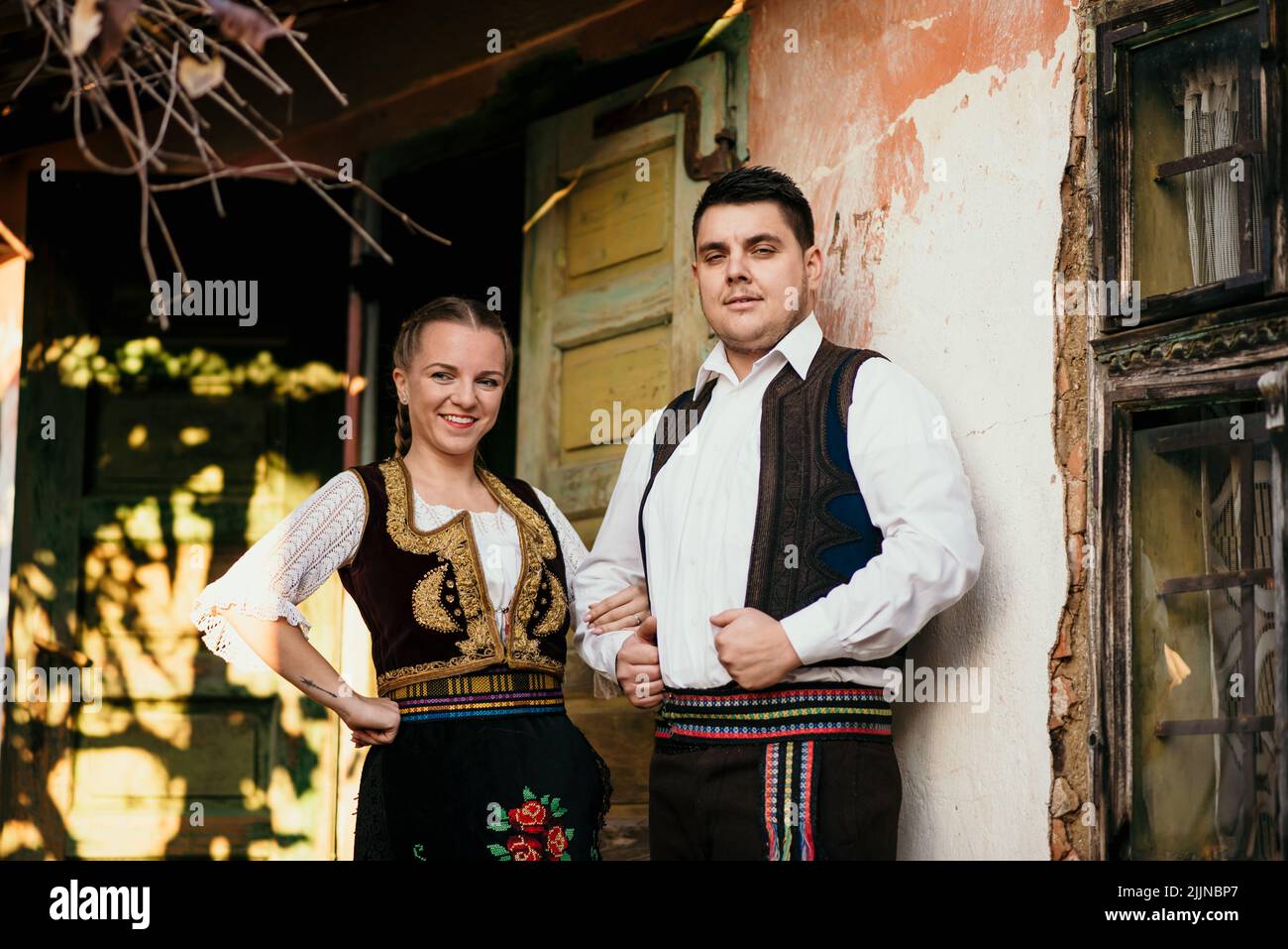 A close-up shot of a young Serbian couple in traditional costume in ...