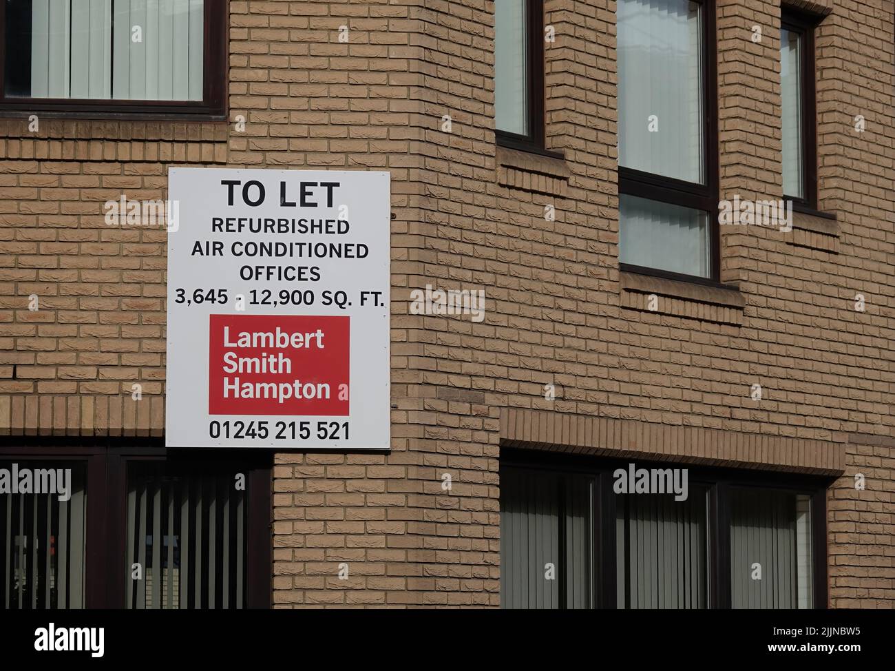 A To Let sign on the exterior wall of refurbished air conditioned ...