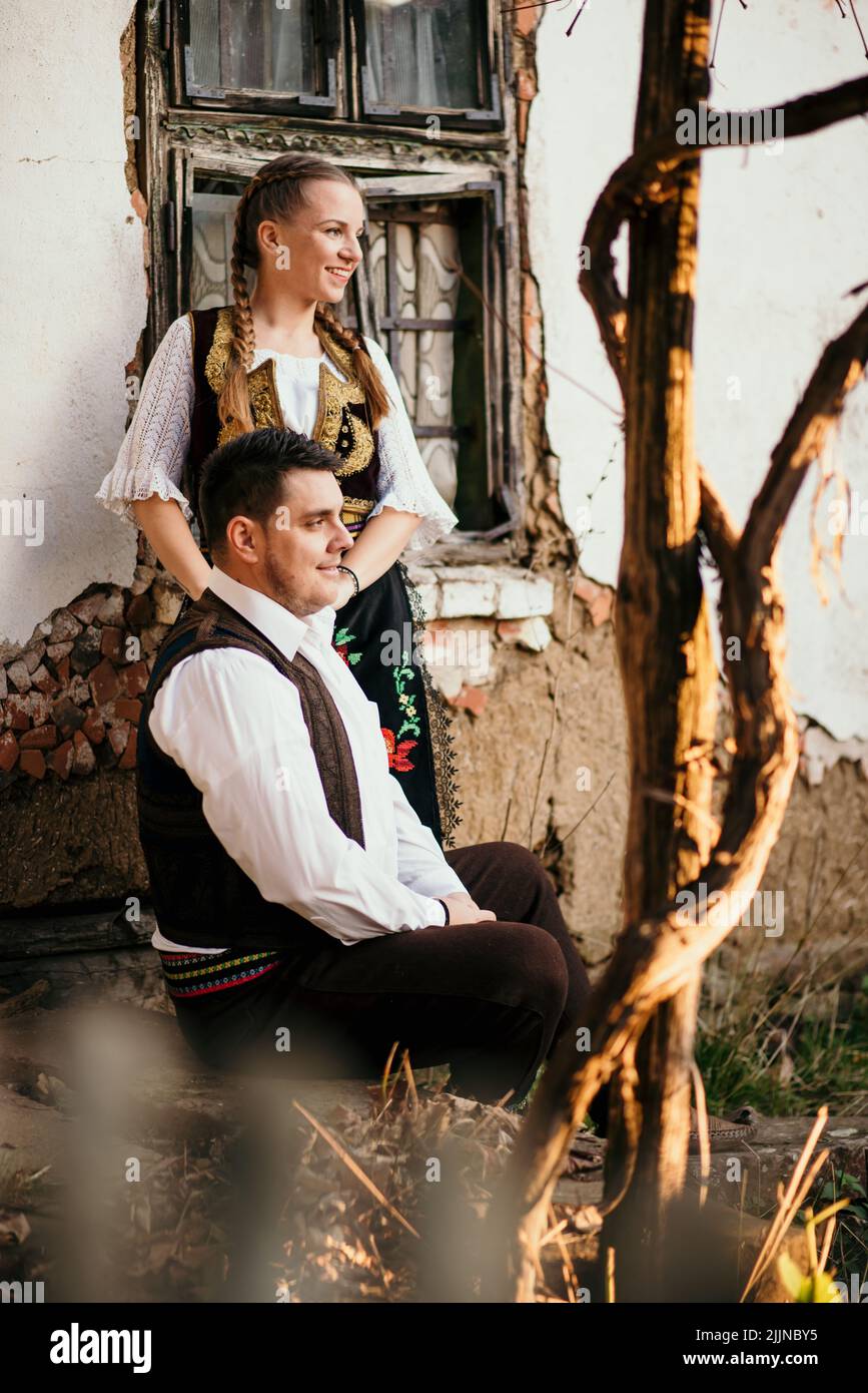 A close-up shot of a young Serbian couple in traditional costume in the ...