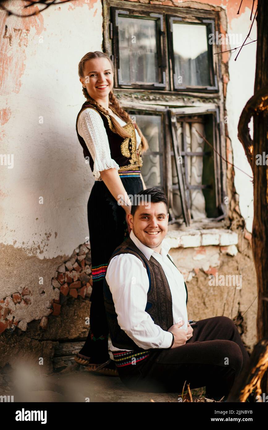 A close-up shot of a young Serbian couple in traditional costume in the ...