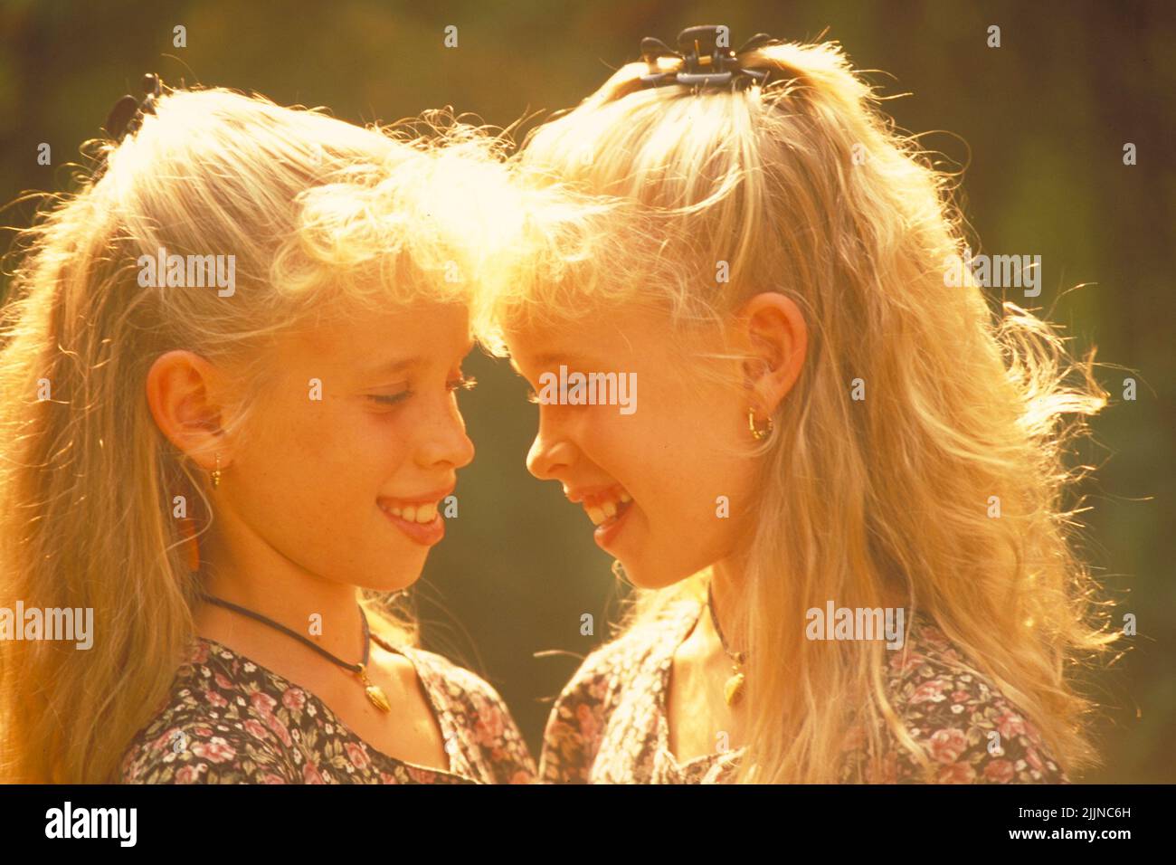 The Pretty young twin girls together laughing and happy in Saint ...