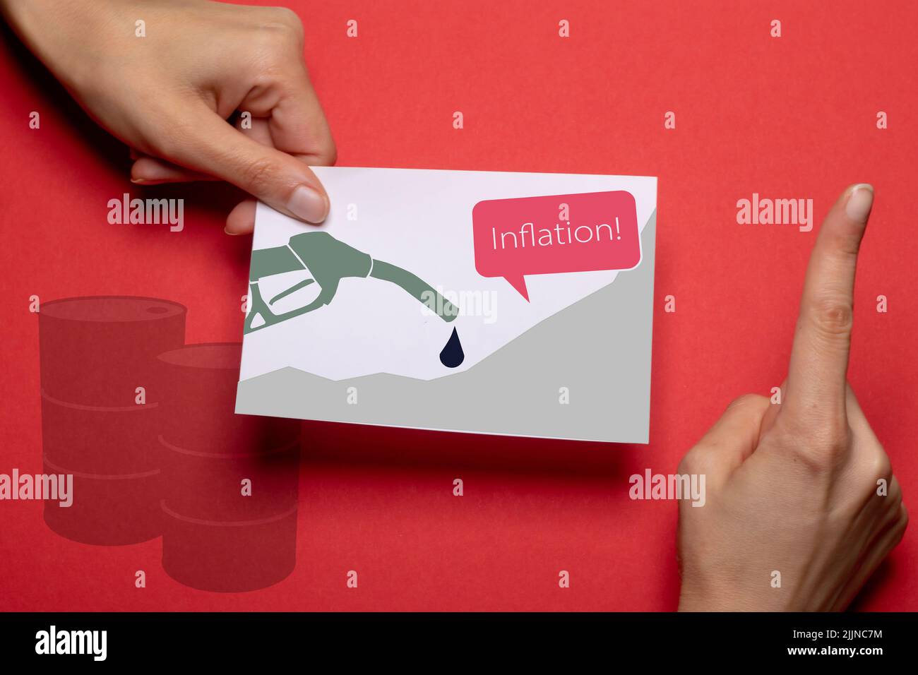 female hand holds a piece of paper with a fuel pump nozzle, a chart and ...