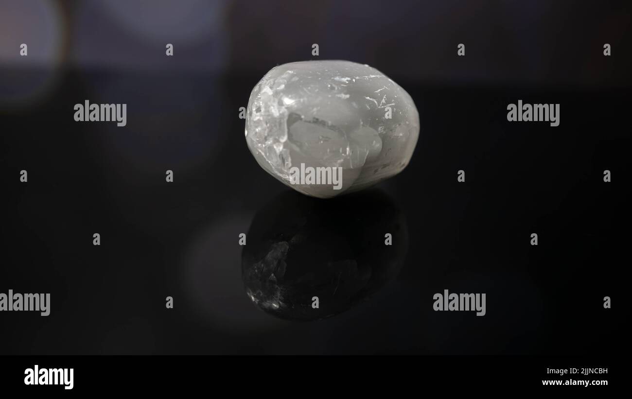 A closeup of a selenite tumbled stone, stone of angels crystal healing ...