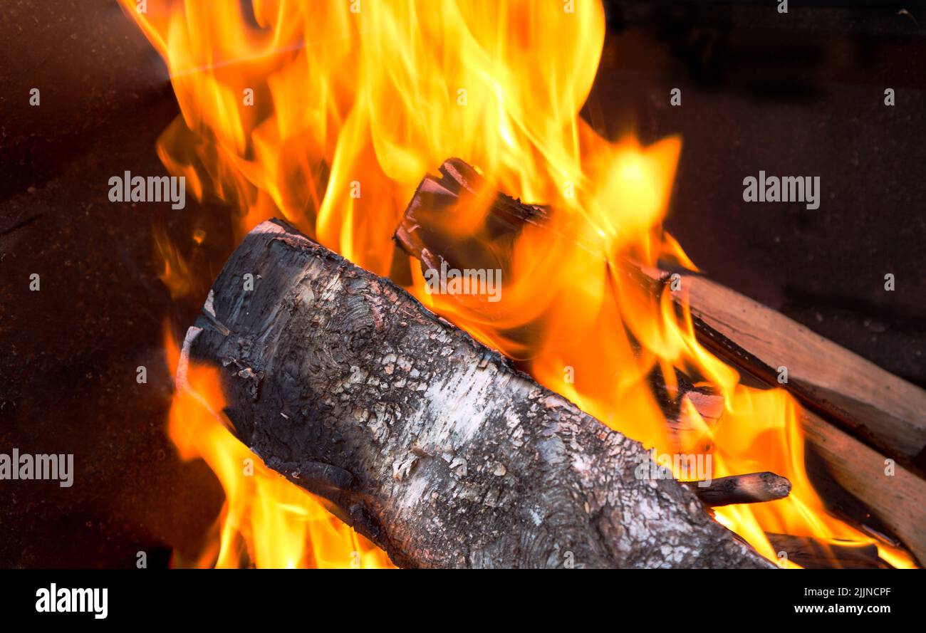 Burning Wood. Campfire flames over burning logs Stock Photo - Alamy