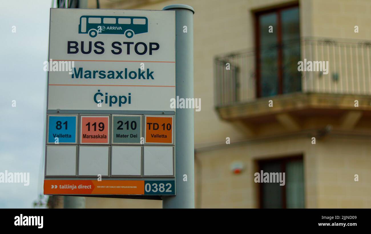 A closeup shot of a bus stop sign in the street of Marsaxlokk, Malta ...