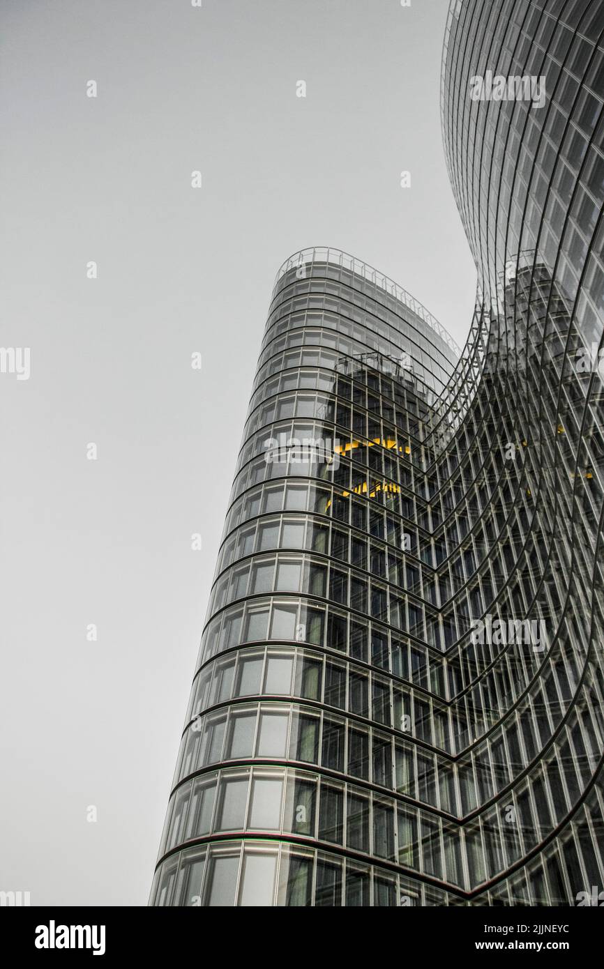 A low angle shot of a modern high rise building with a glass facade ...