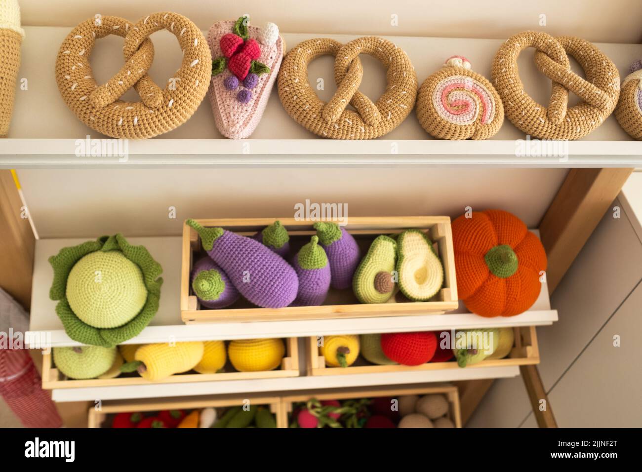 Artificial food in the children's kitchen. On the shelf are vegetables ...
