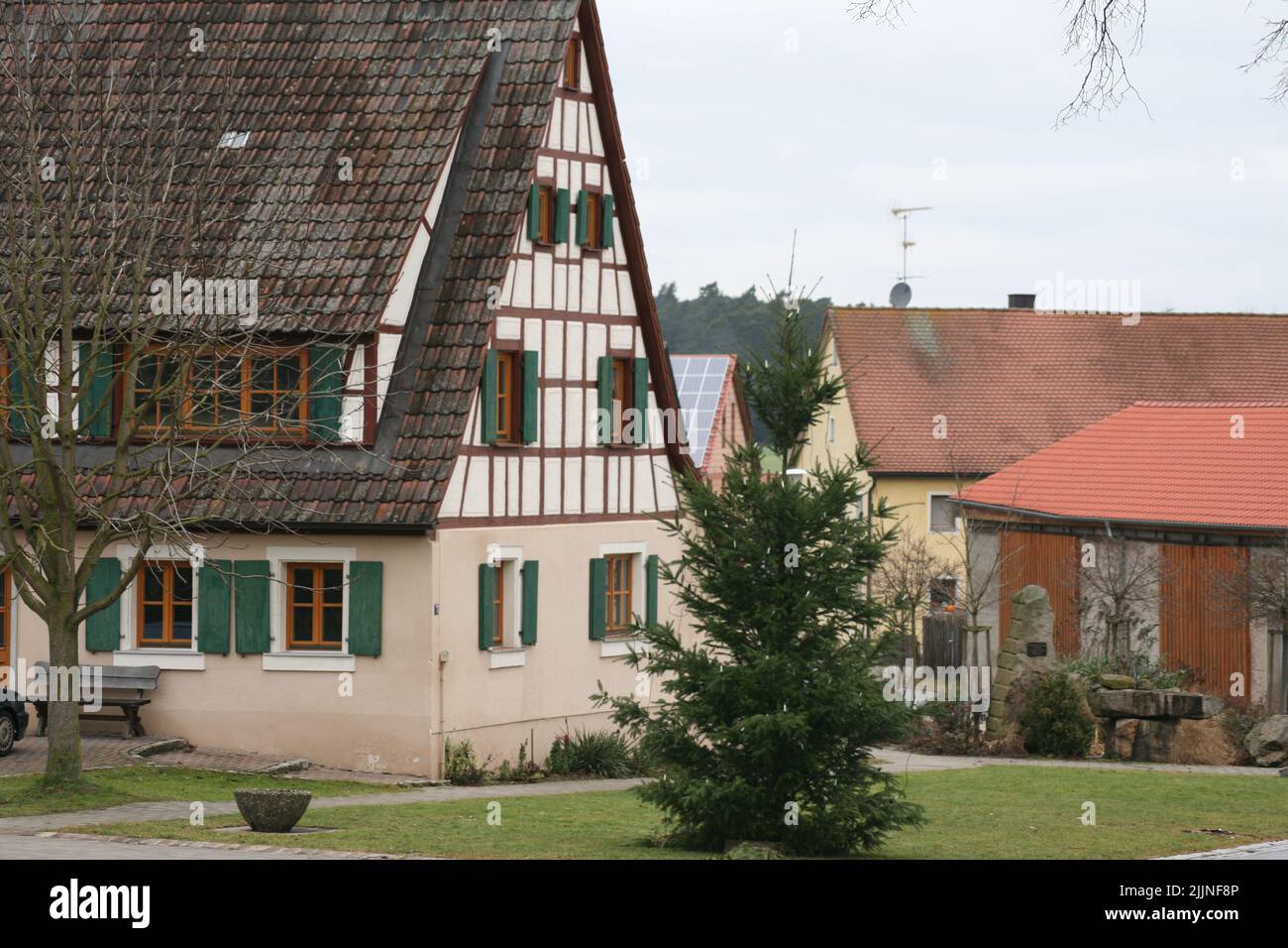 A facade of a house with tall, triangle-shaped roof in a German village ...