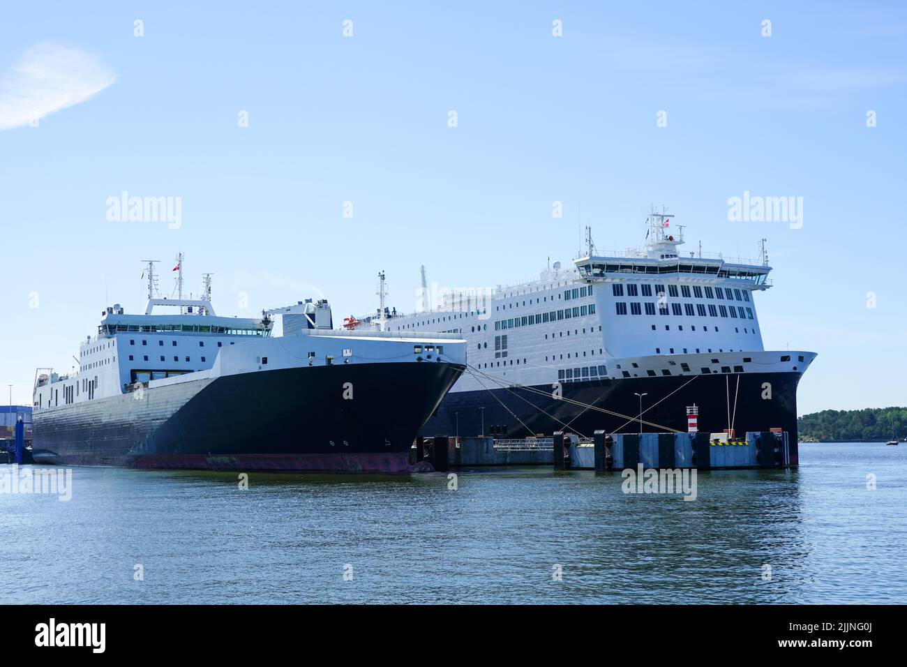 Two large Ro-Ro cargo and passenger ferries moored in the seaport Stock ...