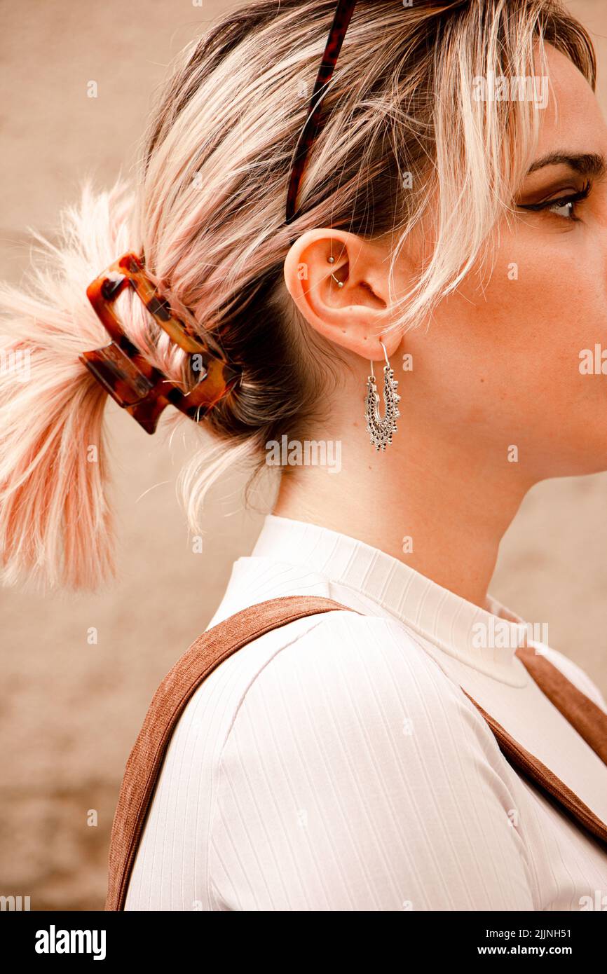 A vertical side view of a female wearing handmade earrings Stock Photo ...