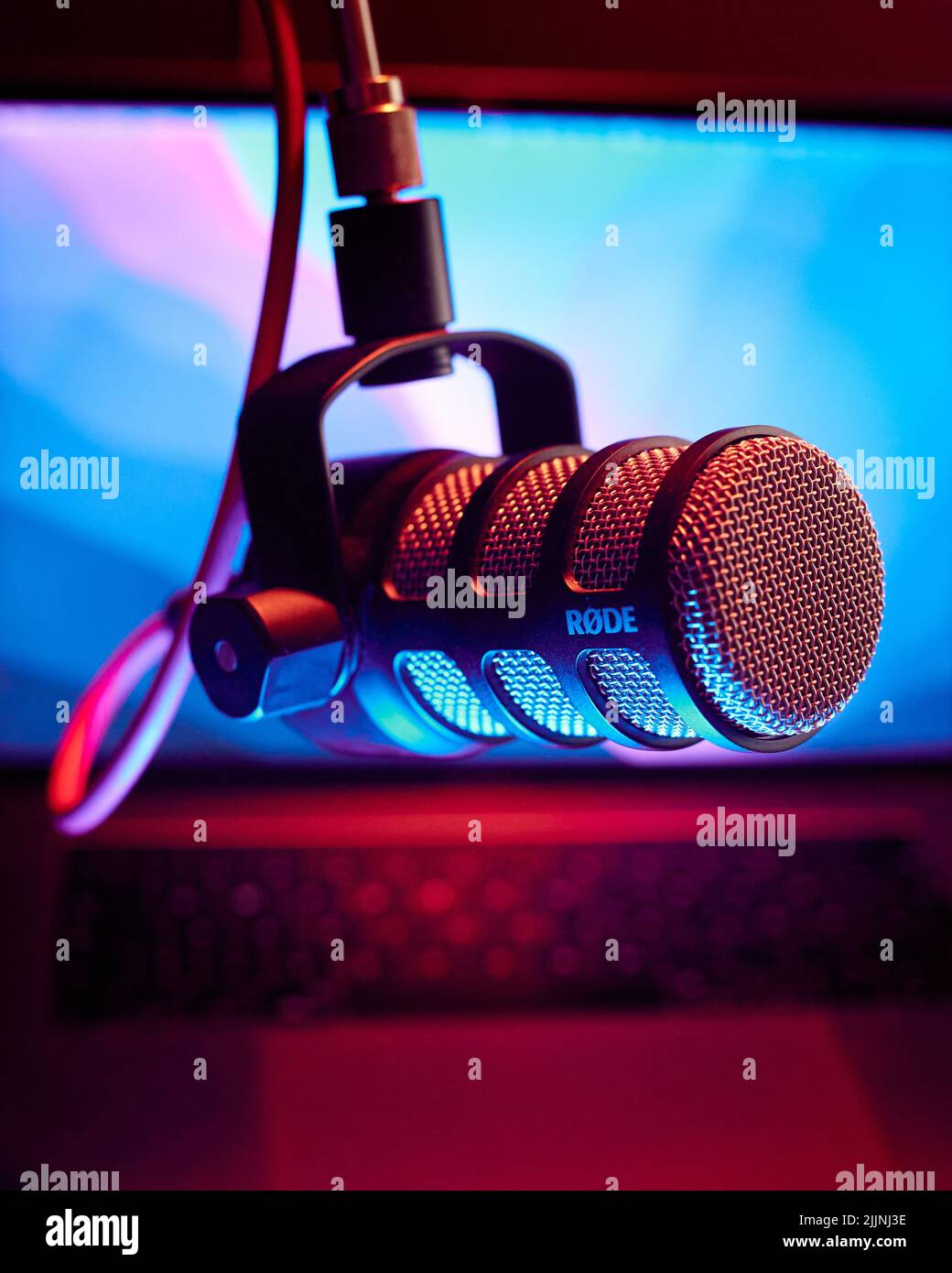 A shallow focus of Rode microphone in front of MacBook Pro Stock Photo ...